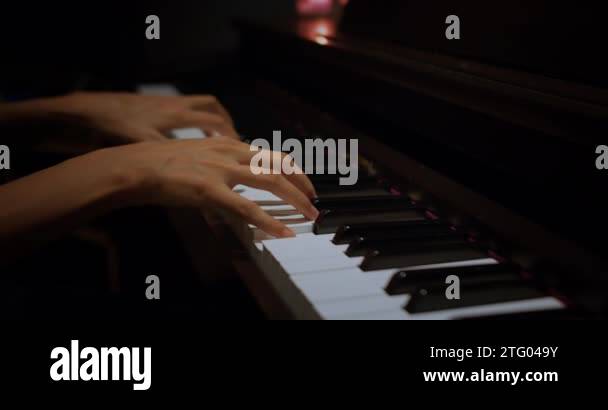 Woman pianist plays gentle classical music on a beautiful grand piano ...