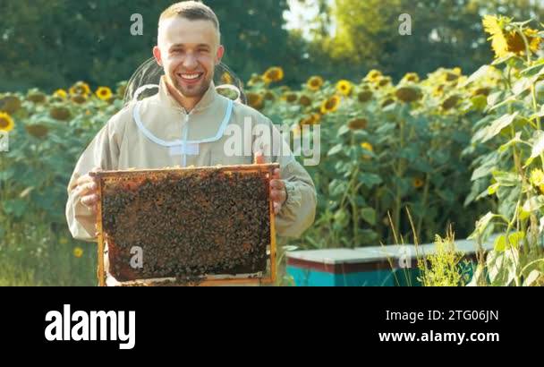 Happy beekeeper worker laughing smiling delightfully standing in ...