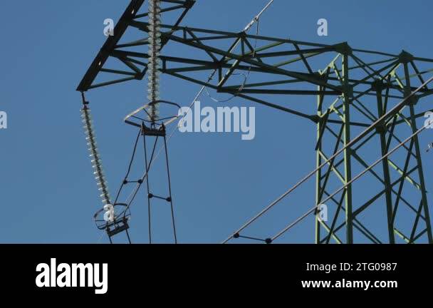 Power lines with sun rays on blue sky. High voltage substation ...
