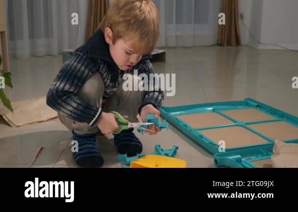 Little Boy Cut with Scissors Plastic Details. Kid Assembling Whiteboard ...