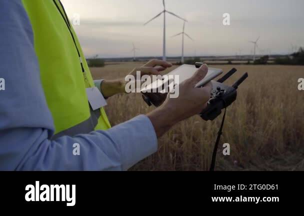 Operator holding remote control and quadcopter. Unmanned aerial copter ...