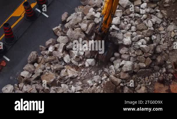Excavator removing debris of collapsed structure. Shot in 4K RAW on a ...