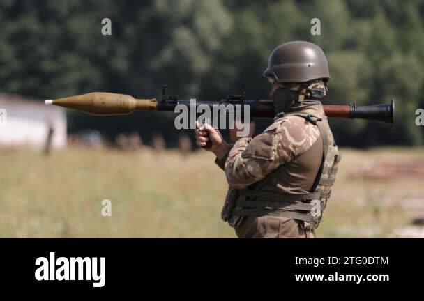 Soldier in uniform, helmet, and body armor fire Precision Shoulder ...