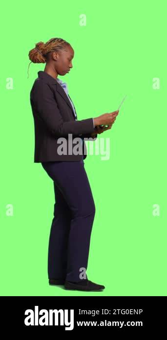 Vertical video: Female office worker working on laptop over full body ...