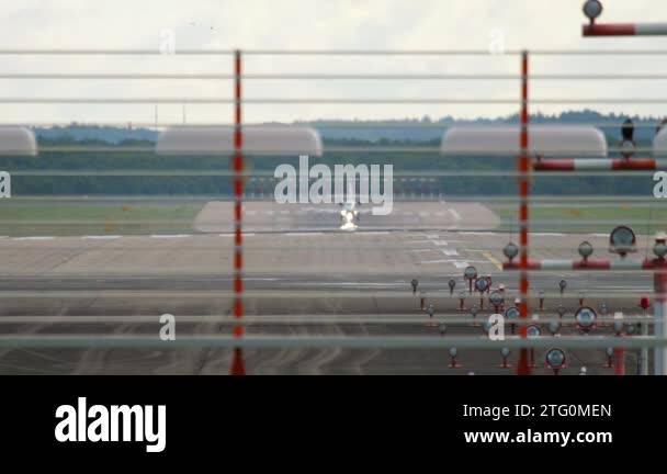 Side view of the runway in the early morning. Landing lights at the ...