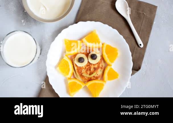 Funny sun face shape snack from pancake,orange on plate. Cute kids ...