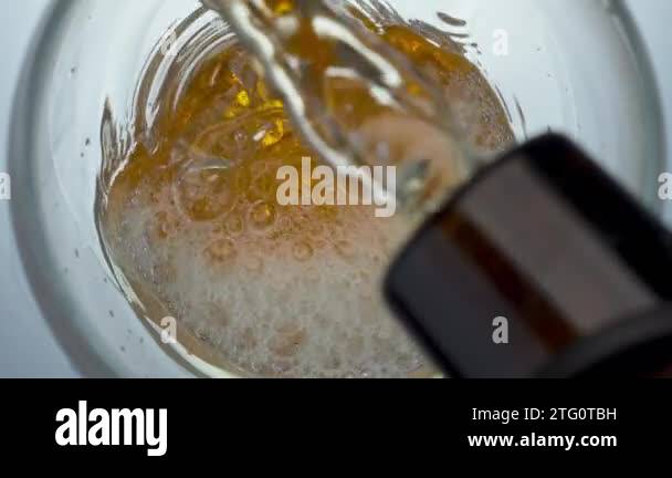 Lager drink filling vessel closeup. Bottled sparkling cold craft ...