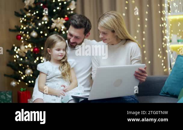 young parents teach their child to use a laptop studying learning ...