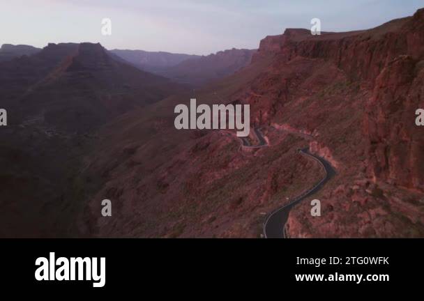 The car drives the road through huge canyons of rock formations during ...