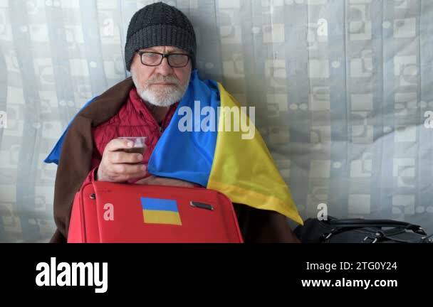 Refugees from Ukraine. An old man and his granddaughter are waiting for ...