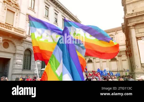People with peace rainbow flags waving in slow motion at a ...