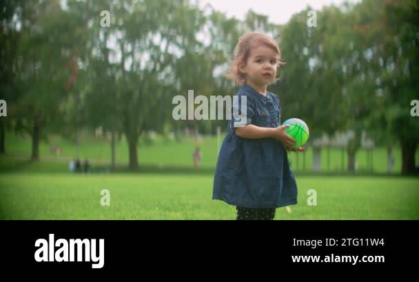Cute baby girl exploring a park in summer. Real life, candid footage ...