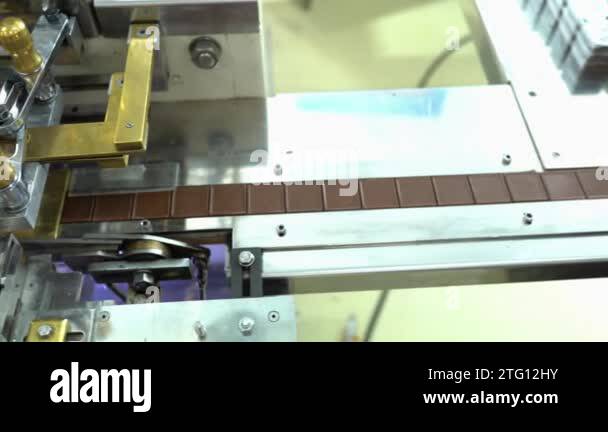 Automated Production line of chocolate pralines in a factory. Different ...