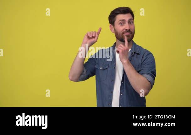 Handsome man nods approvingly and pointing to the side with his hands ...