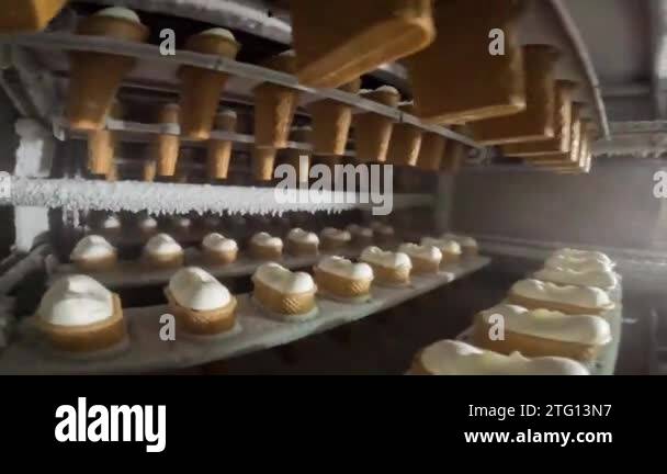 Ice cream after freezing at the factory. Ice cream production process ...