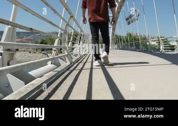 Image of mans feet crossing the bridge, image of walking step by step, stepping over the bridge ...