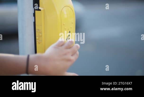 Hand pressing a button at traffic lights on pedestrian crossing switch ...