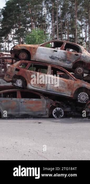 This stock vertical video shows a dump of shot and burned cars in Irpin ...