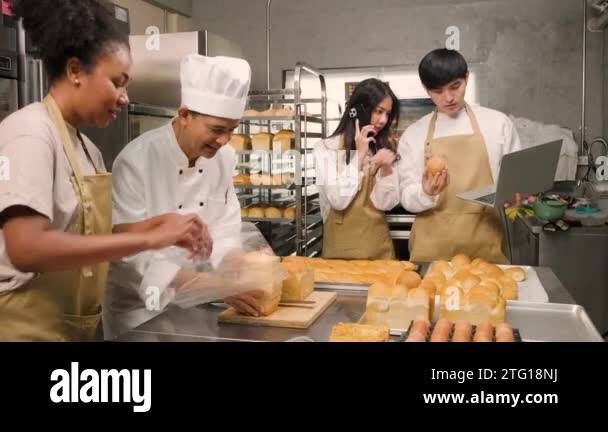 A chef's team staff who make bread dough and pastry foods are busy with ...