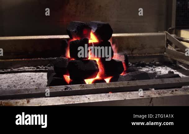 Beatiful closeup of a hexagon shaped pile of coals with hole in the ...