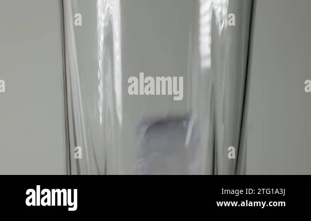 Ice cube pouring dropping into a tall glass bouncing shaking on white background Stock Video ...