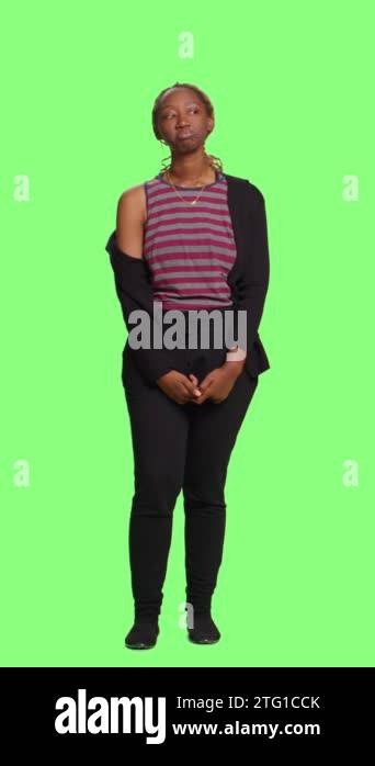 Vertical video: Impatient model standing in line on full body green ...