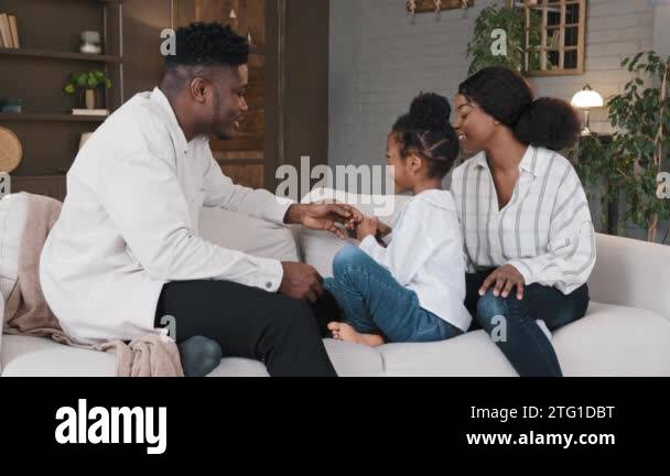 African American parent spending time with child girl daughter sitting ...