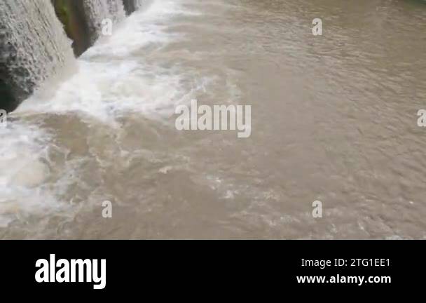 A small waterfall that regulates the flow of a river that has an ...