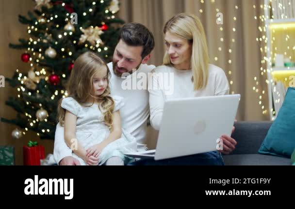 young parents teach their child to use a laptop studying learning ...