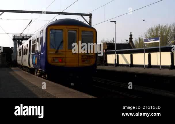 Two railroad trains of Northern Rail. One is leaving the Manchester ...