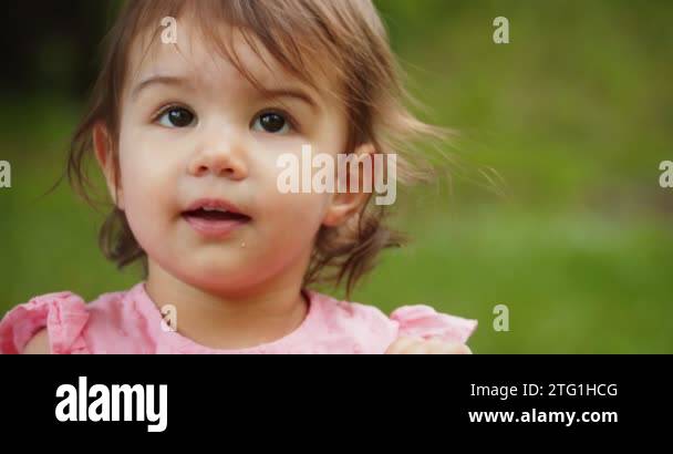Cute baby girl exploring a park in summer. Real life, candid 4K footage ...