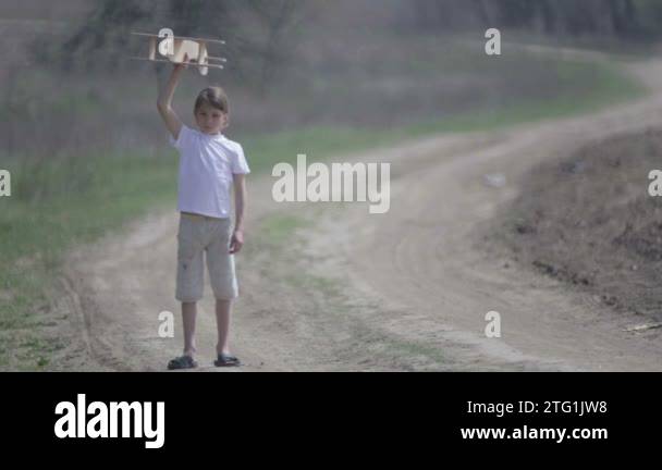 Caucasian boy playing with a model airplane. Portrait of a child with a ...