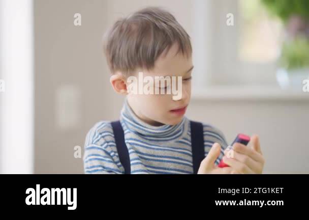 Front view smiling autistic curios boy painting with unrecognizable ...