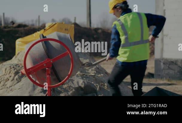Construction worker putting cement in mixer with shovel Stock Video ...