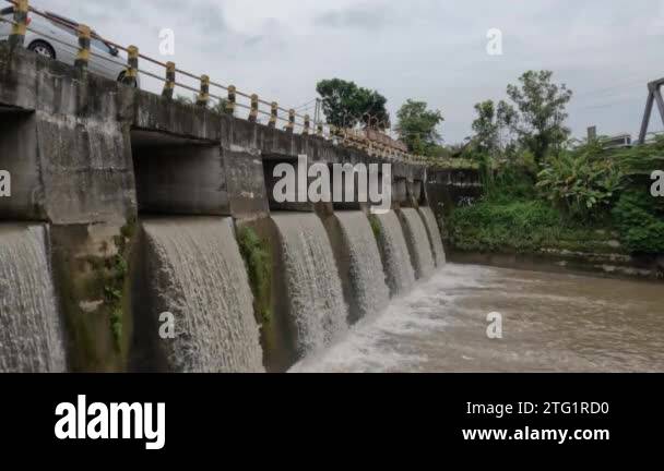 A small waterfall that regulates the flow of a river that has an ...