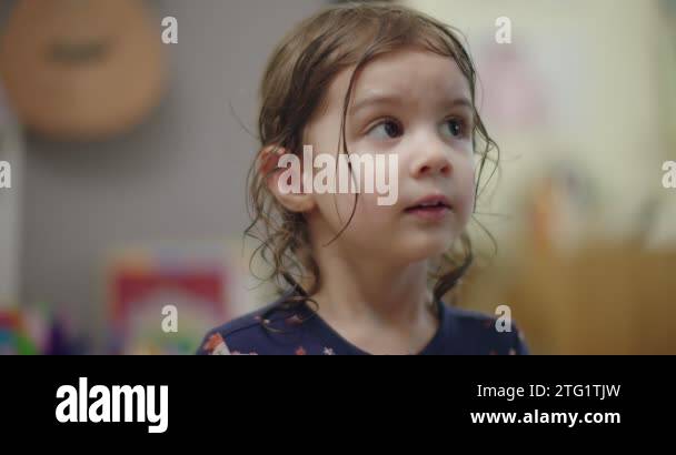 Portrait of a cute 2-year toddler girl going about her daily routine. Shot in 4K on a cinema ...