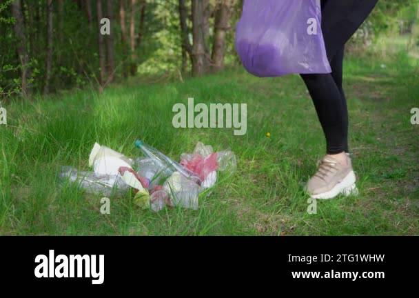 Girl pick up trash doing plogging.Plogging concept. Collecting the ...