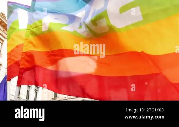 People with peace rainbow flags waving in slow motion at a ...