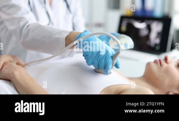 Doctor using ultrasound machine examining a woman chest and heart ...