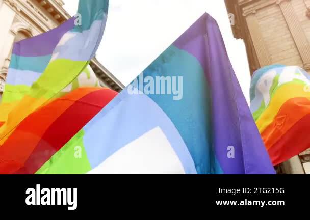 People with peace rainbow flags waving in slow motion at a ...