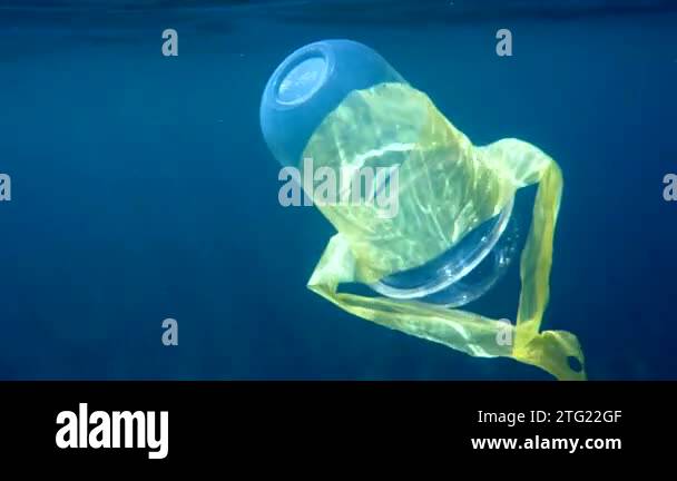 Plastic Pollution In Ocean. Plastic cocktail cup floating in tropical ...