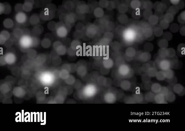 Beautiful flow down moving white bokeh bubbles lights Seamless loop motion on black background ...