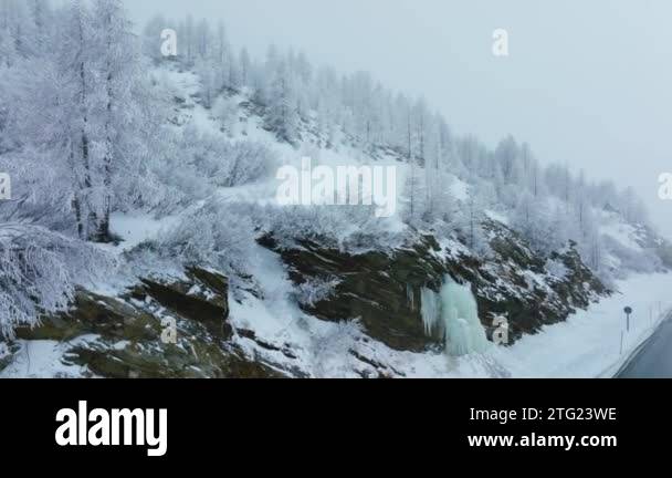 Rows of stalactite icicles, similar to lace frills, hang from the base ...