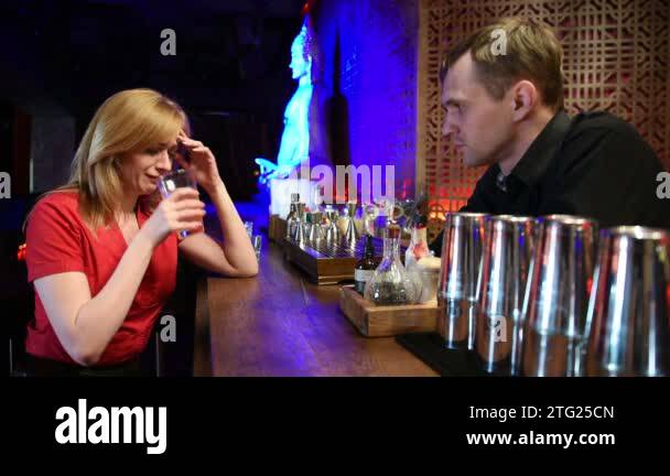 sad girl crying at the bar. drinks cocktails, night time. girl ...