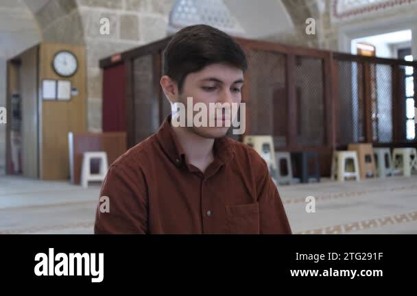 Young muslim reciting a prayer with his mouth moving, muslim reciting a ...