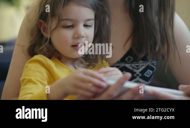 Portrait of a cute 2-year toddler girl going about her daily routine ...