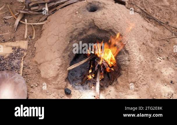 A traditional clay oven with wood fire at a nomads' hut in the Sahara ...