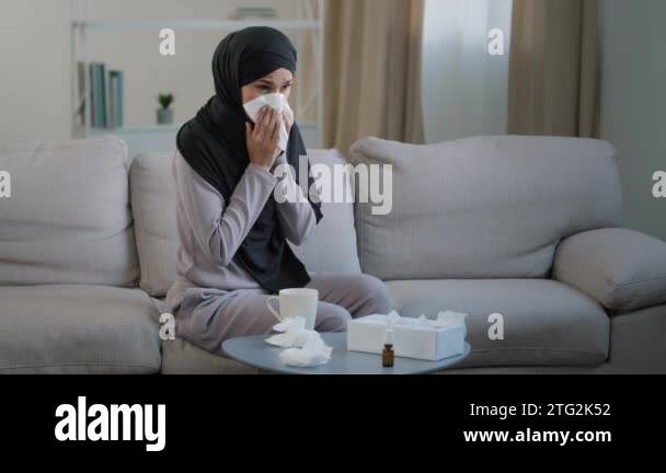 Sick arabian muslim young unhealthy woman in hijab suffer from runny ...