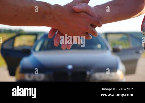 Handshake between salesman and new owner of automobile after successful ...