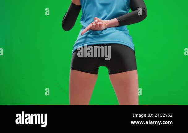Back view of female volleyball player showing finger gestures behind ...